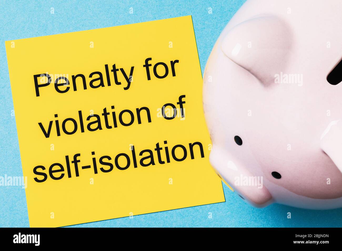 Piggy bank and note with text on a blue background, top view. The ...