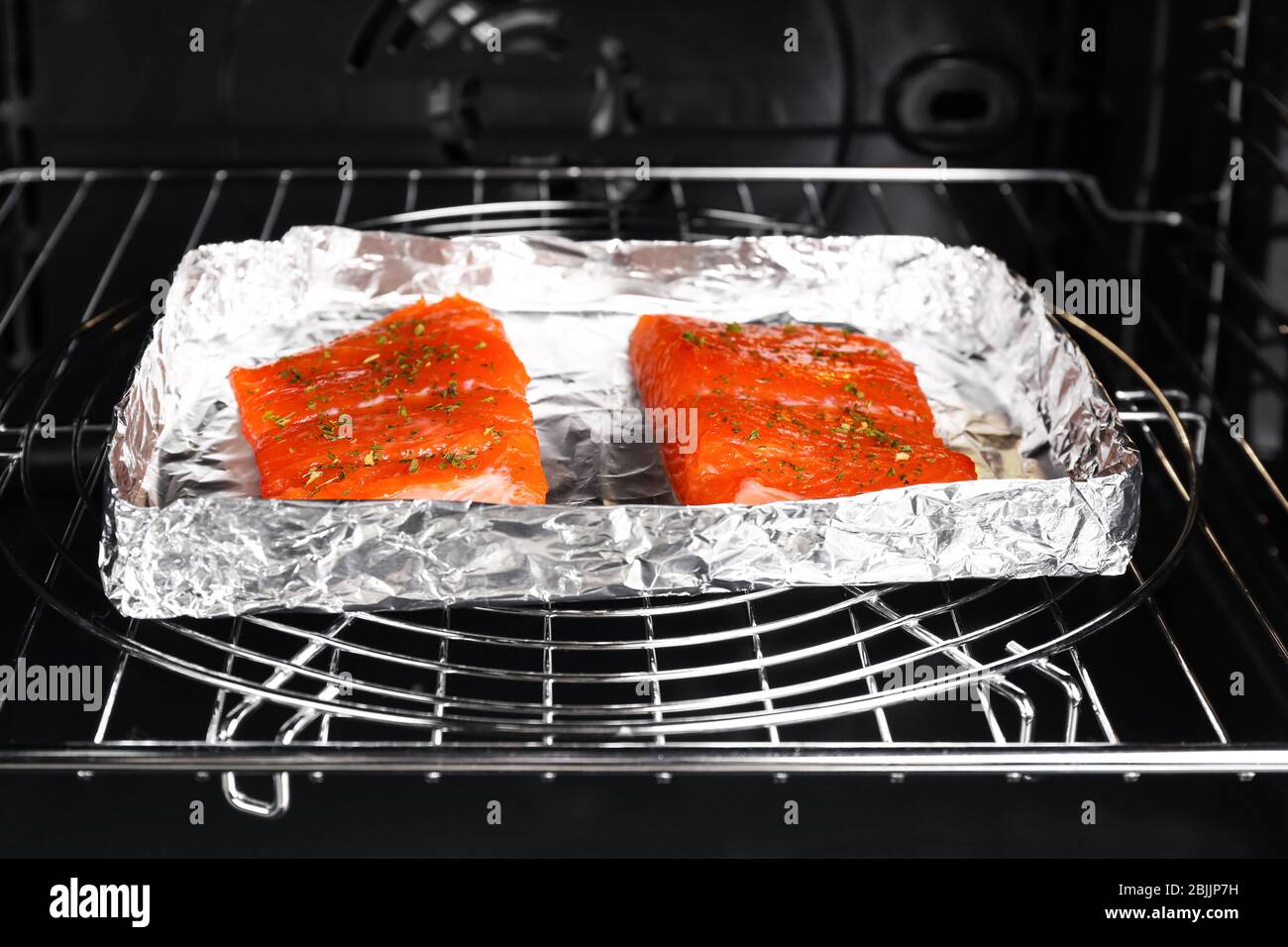 Raw fish fillets in oven Stock Photo - Alamy