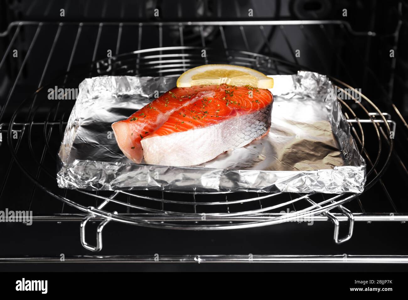 Raw fish fillet in oven Stock Photo - Alamy