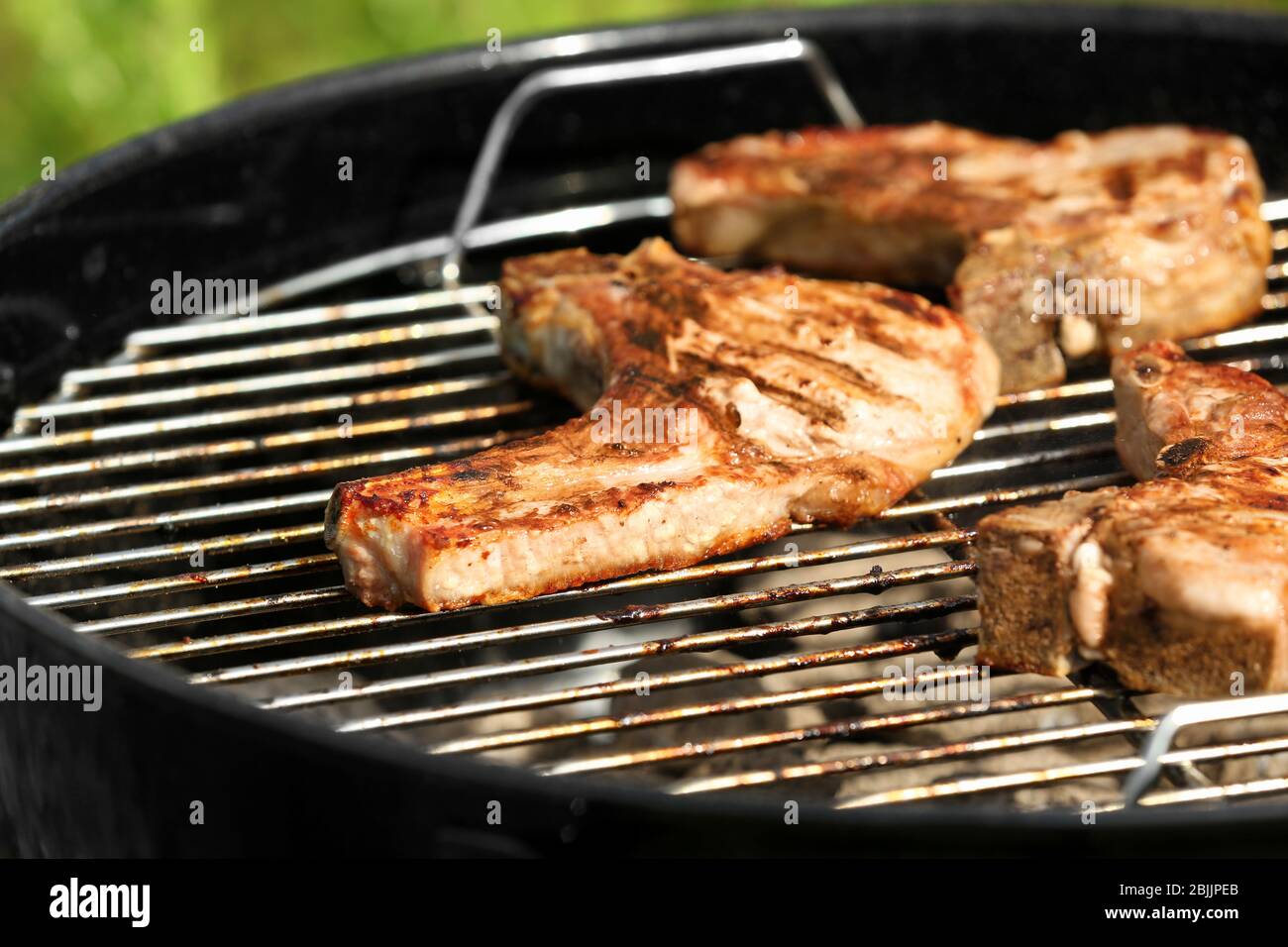 Tasty steaks on barbecue grill, close up Stock Photo - Alamy