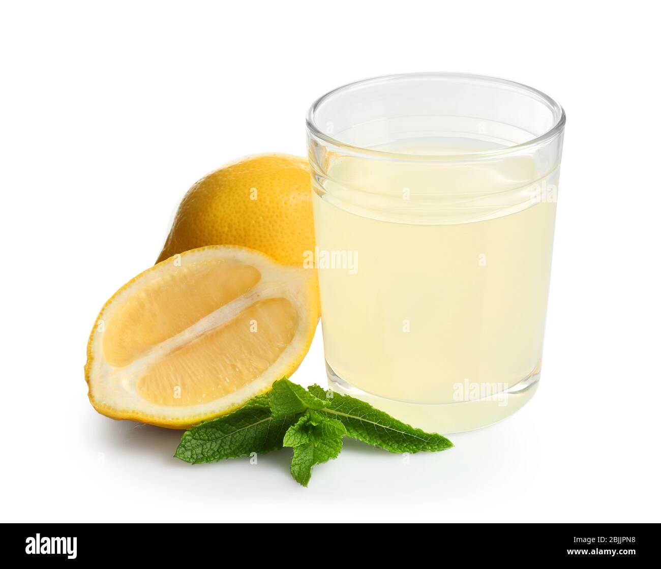 Glass of fresh lemon juice on white background Stock Photo - Alamy