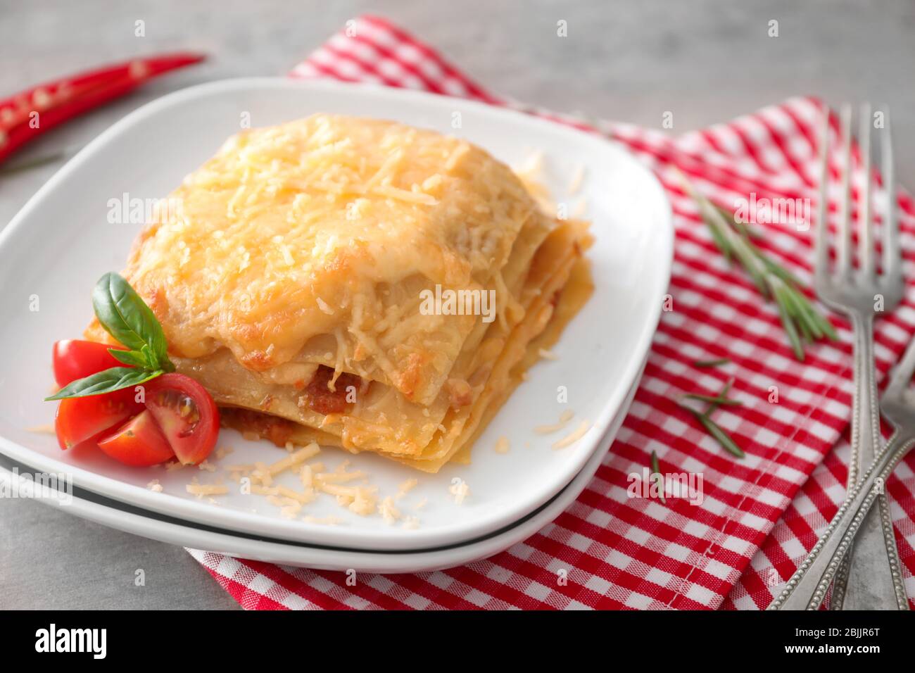 Plate with tasty lasagna on table Stock Photo - Alamy