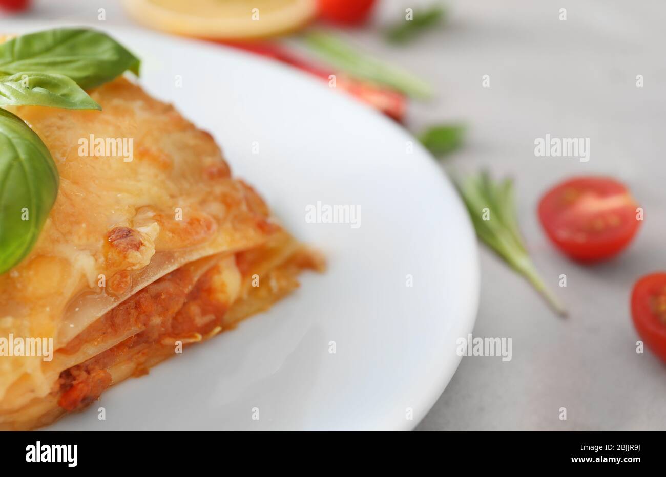 Plate with tasty lasagna on table Stock Photo - Alamy