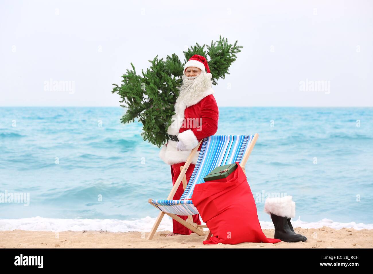 Authentic Santa Claus with Christmas tree and bag full of gifts on ...