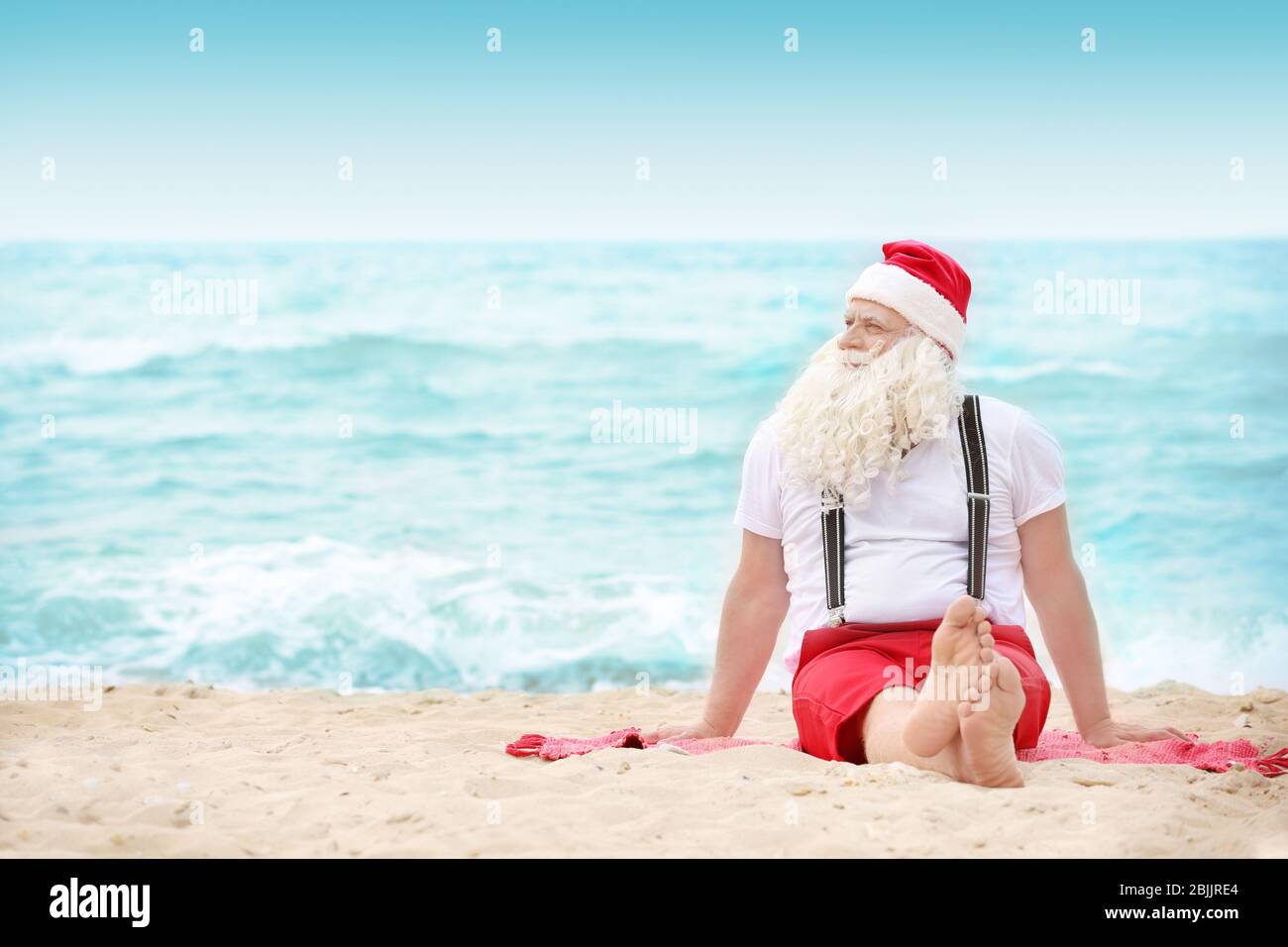 Authentic Santa Claus sitting on beach Stock Photo - Alamy