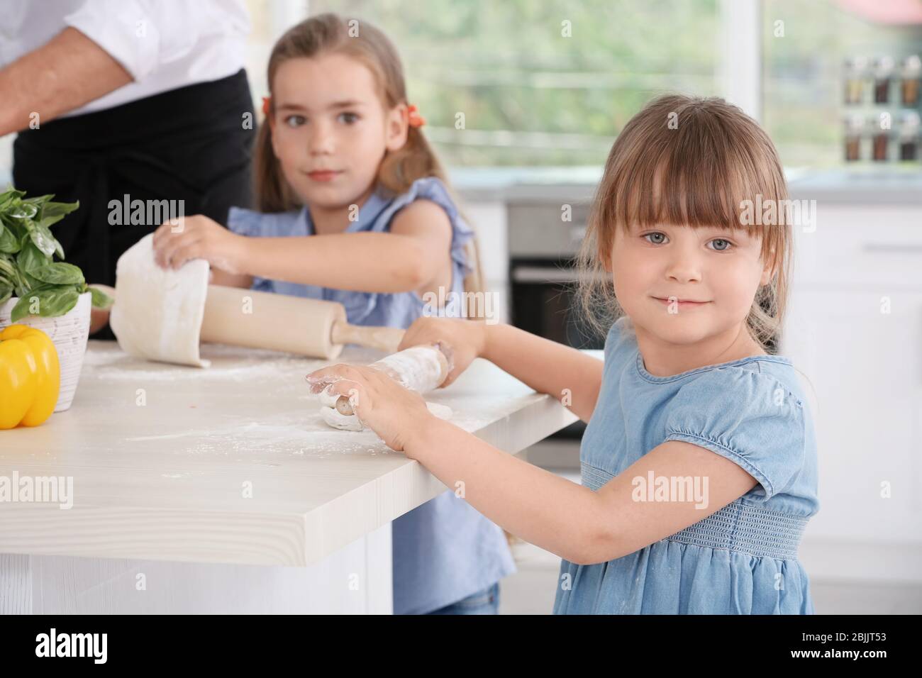Cute children in kitchen during cooking classes Stock Photo - Alamy