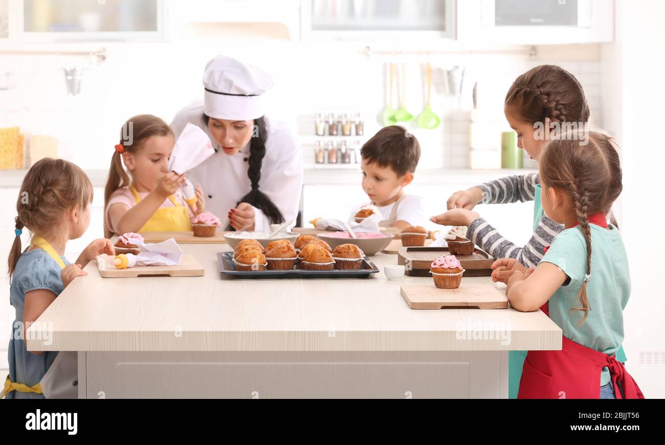 Group of children and teacher in kitchen during cooking classes Stock ...