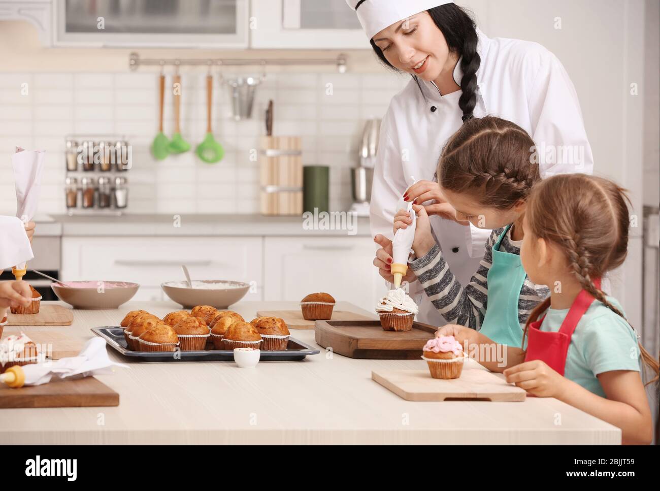Children and teacher in kitchen during cooking classes Stock Photo - Alamy