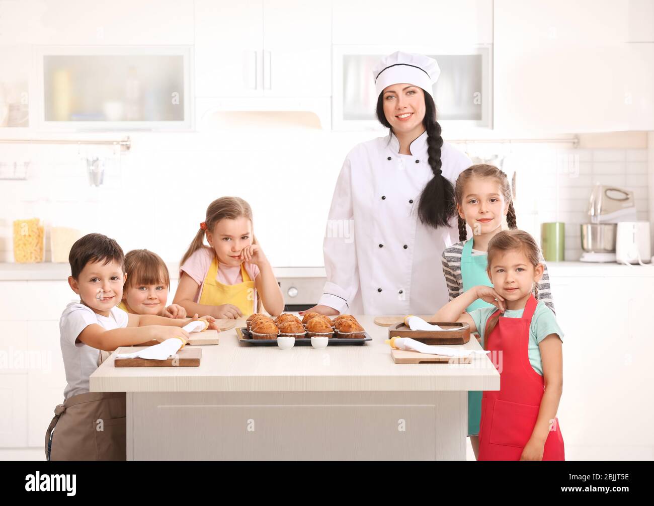 Group of children and teacher in kitchen during cooking classes Stock ...