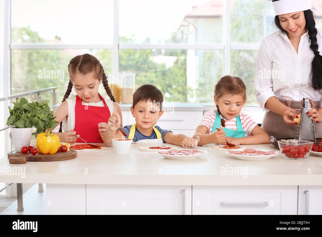 Group of children and teacher in kitchen during cooking classes Stock ...