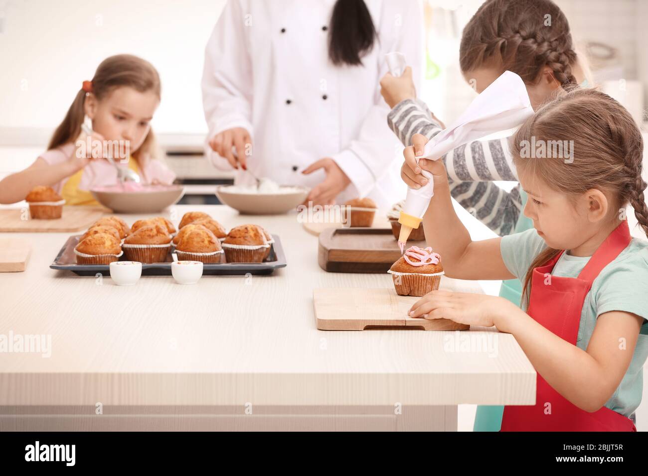 Group of children and teacher in kitchen during cooking classes Stock ...