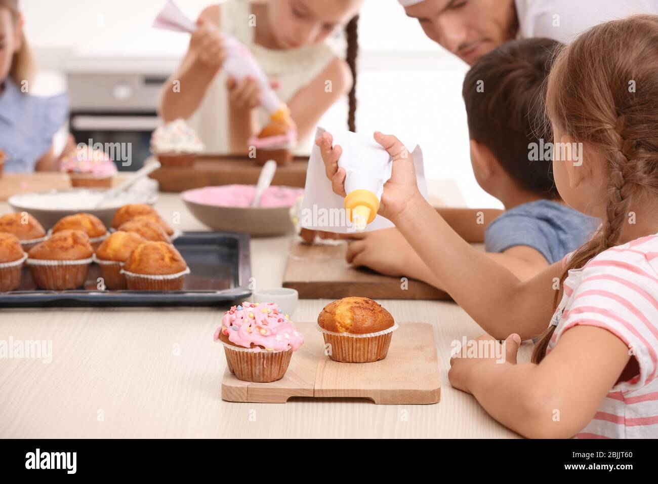 Group of children and teacher in kitchen during cooking classes Stock ...