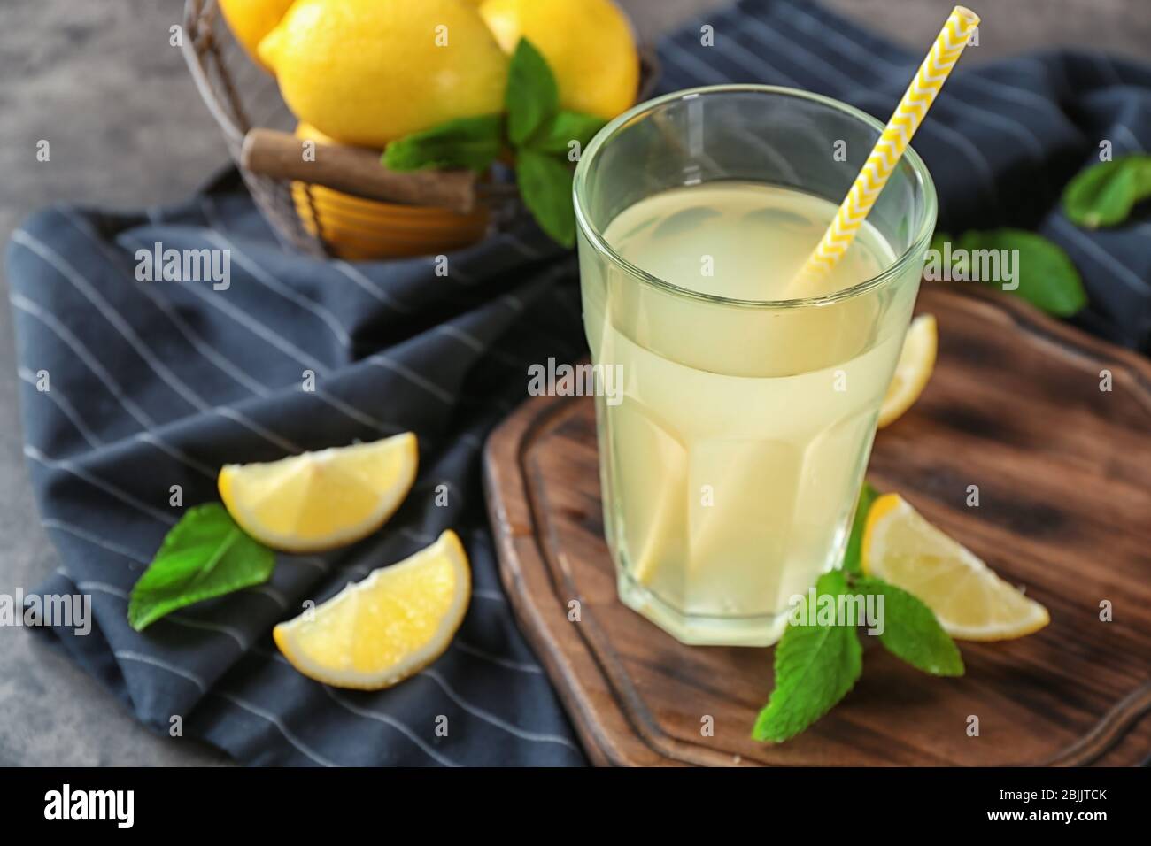 Composition with glass of lemon juice and fresh lemons on table Stock ...