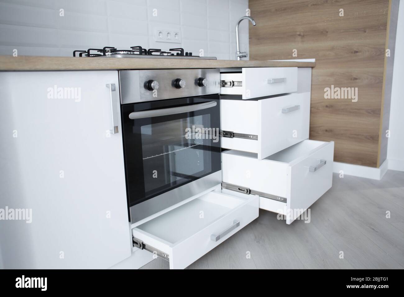 Interior of light modern kitchen with stove Stock Photo - Alamy