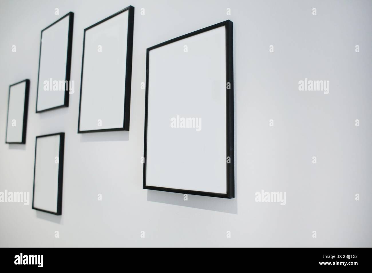 Blank photos frame on the wall Stock Photo - Alamy