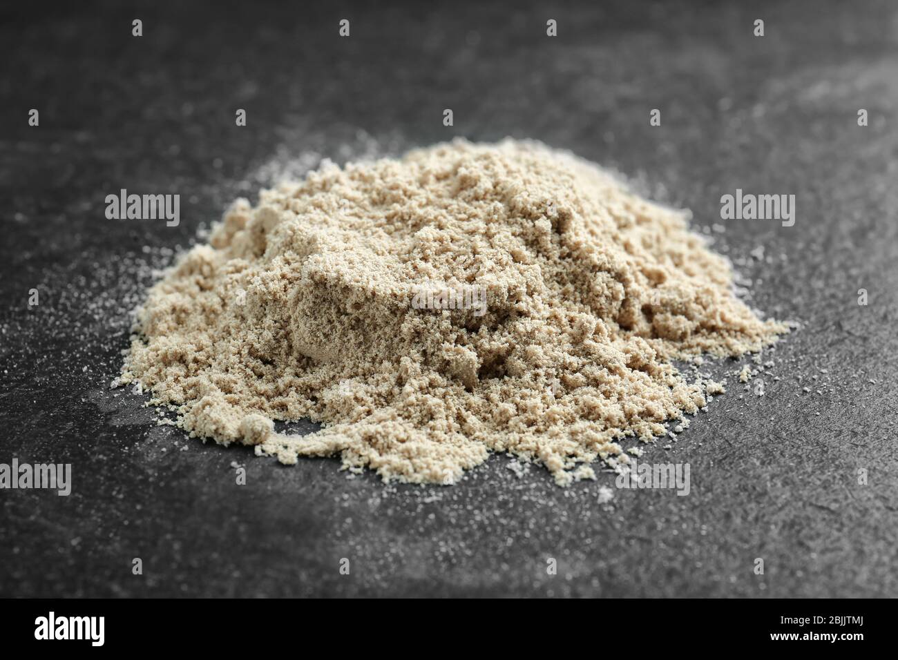 Protein powder on dark background Stock Photo - Alamy