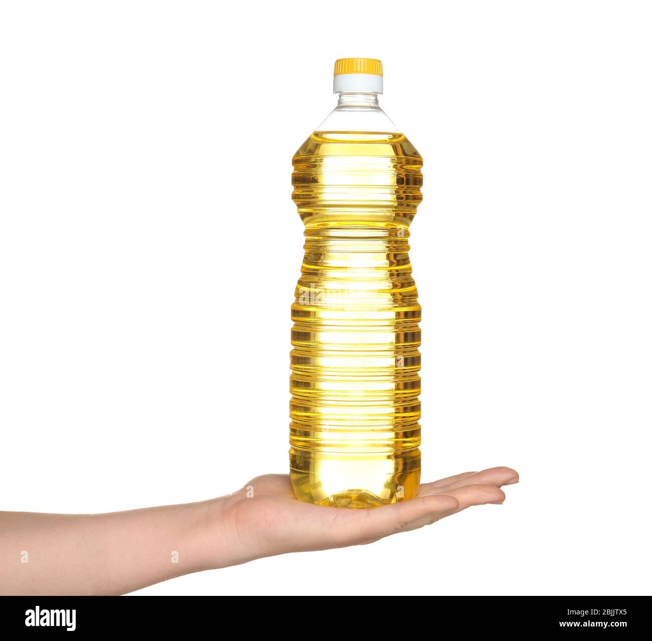 Female hand holding bottle of cooking oil on white background Stock ...