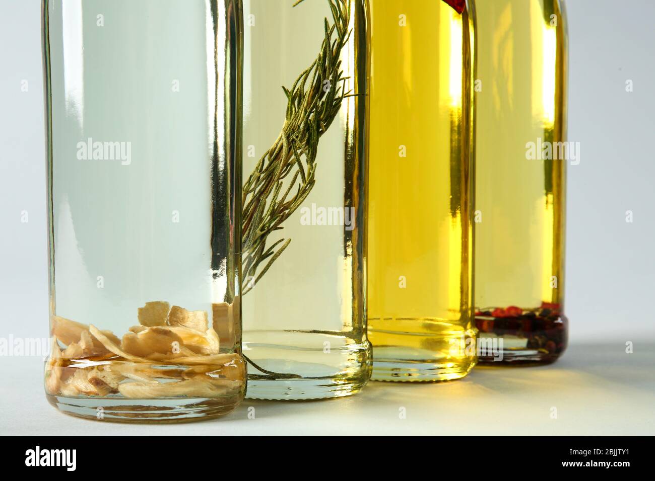 Bottles of cooking oil on light background Stock Photo - Alamy