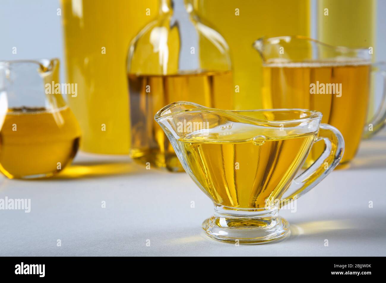 Composition with cooking oil on light background Stock Photo - Alamy
