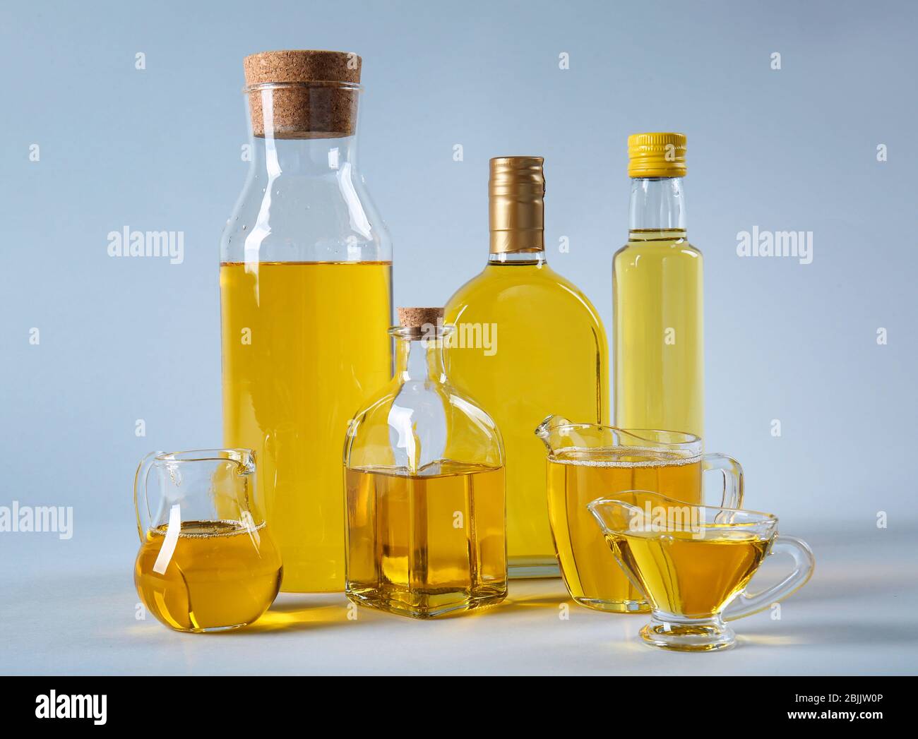Composition with cooking oil on light background Stock Photo - Alamy