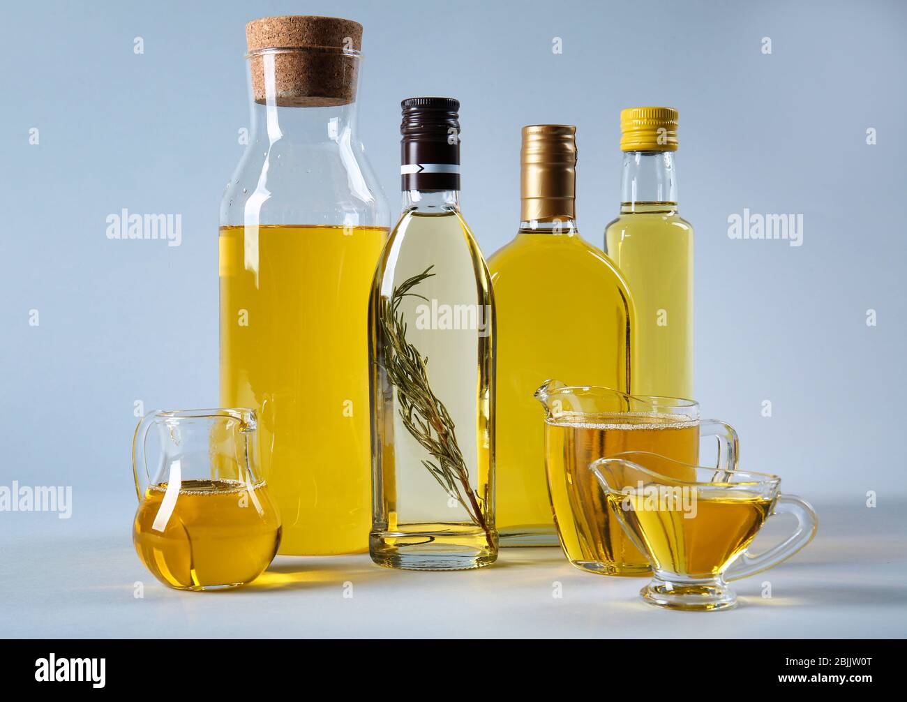 Composition with cooking oil on light background Stock Photo - Alamy