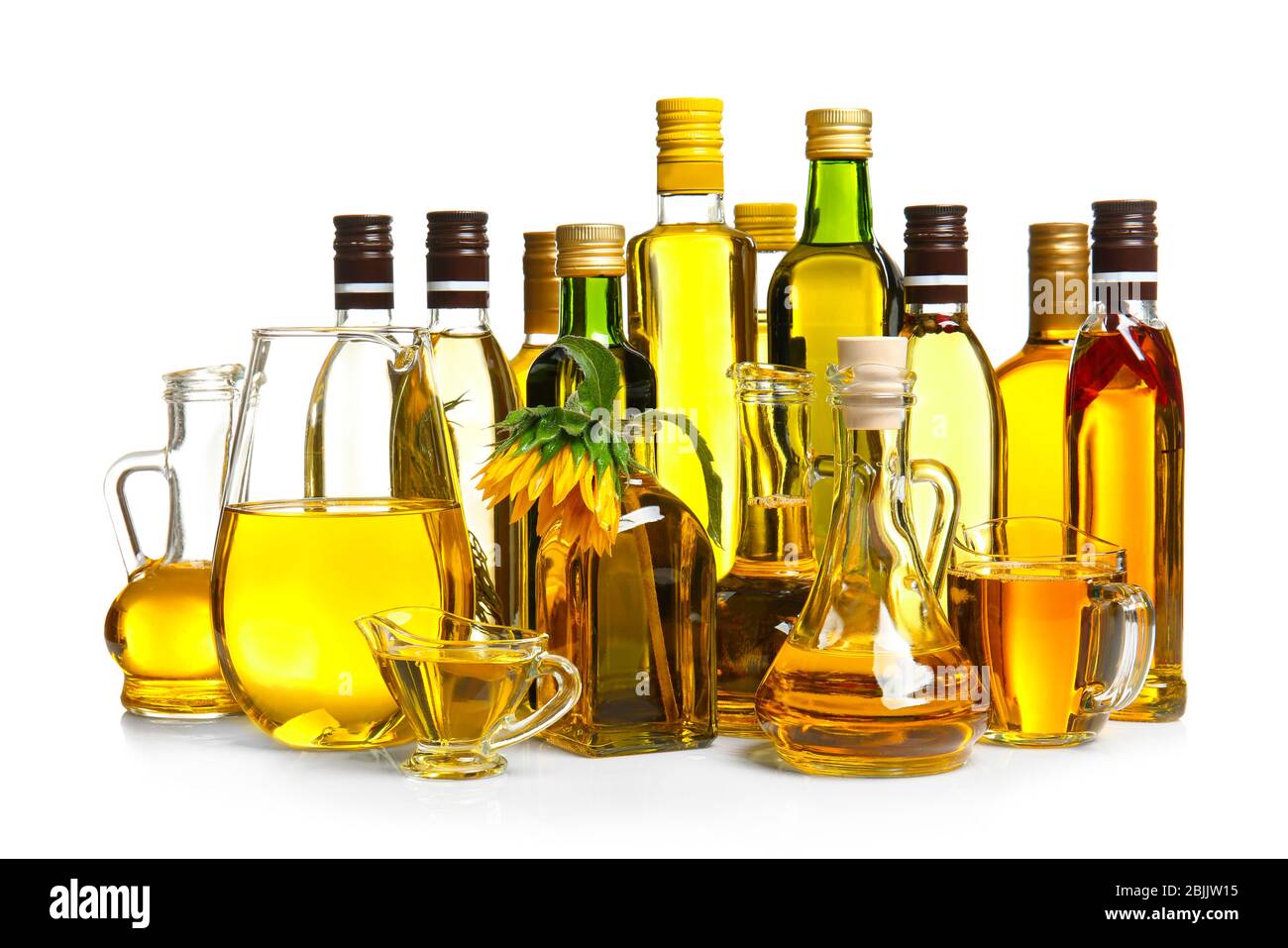 Composition with cooking oil and sunflower on white background Stock ...