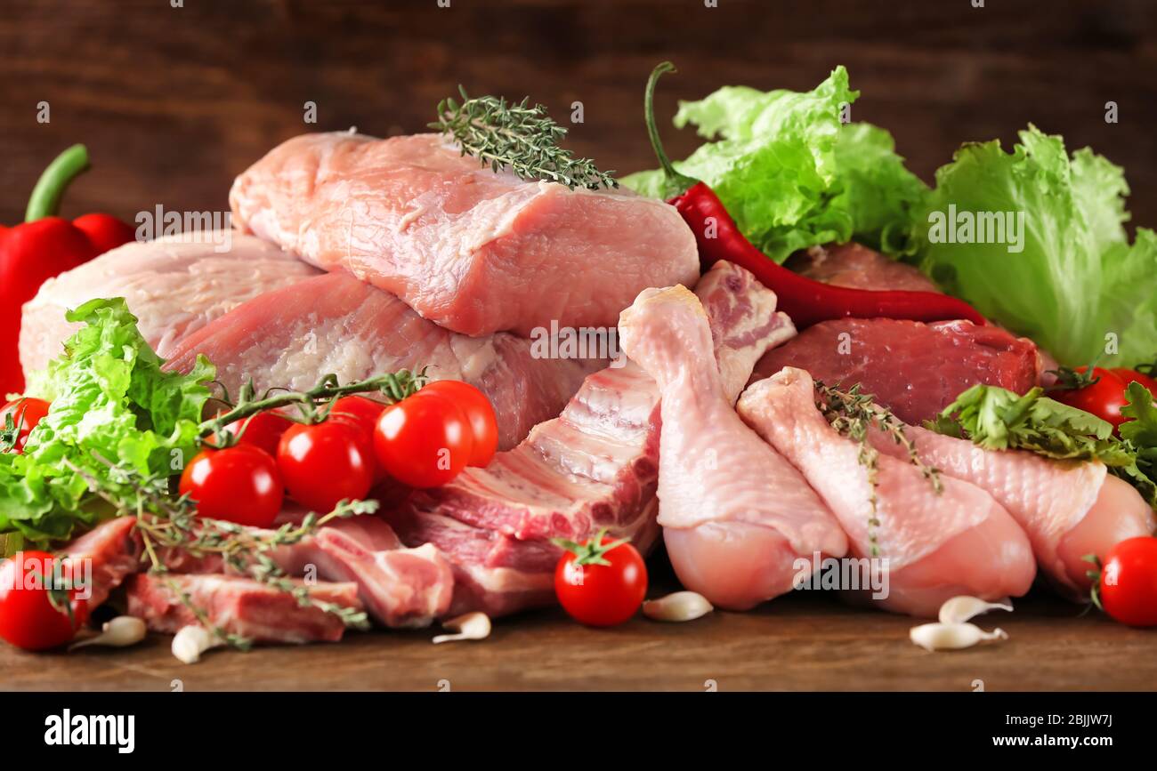 Pieces of different fresh meat on kitchen table Stock Photo - Alamy