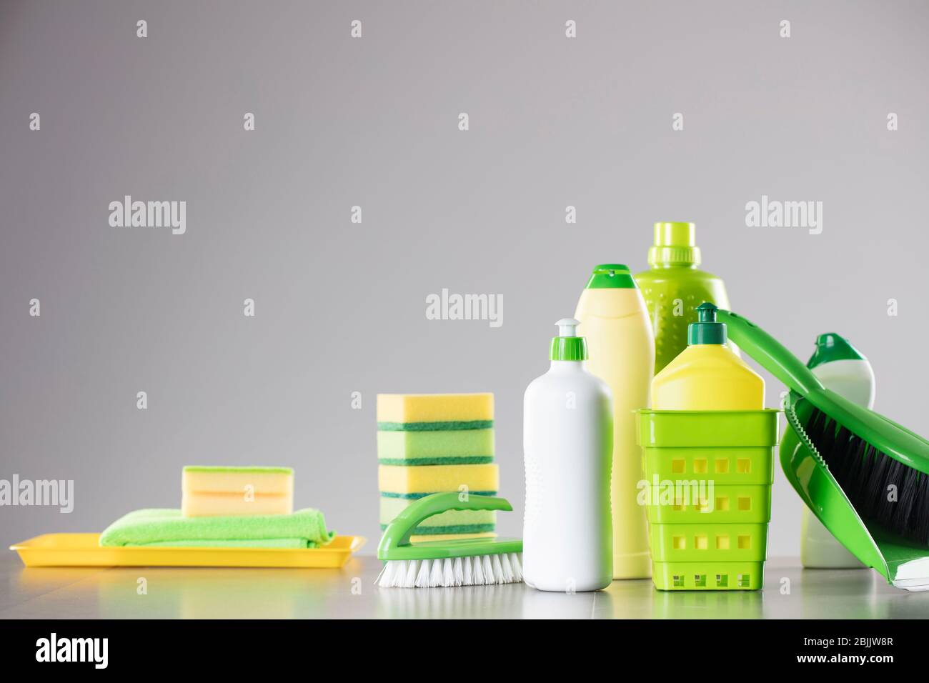 Spring house cleaning. Colorful cleaning kit on white-off background ...