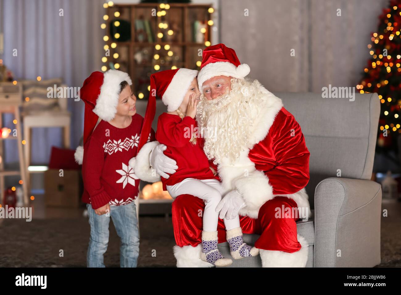 Children telling Santa their wishes in room with beautiful Christmas ...