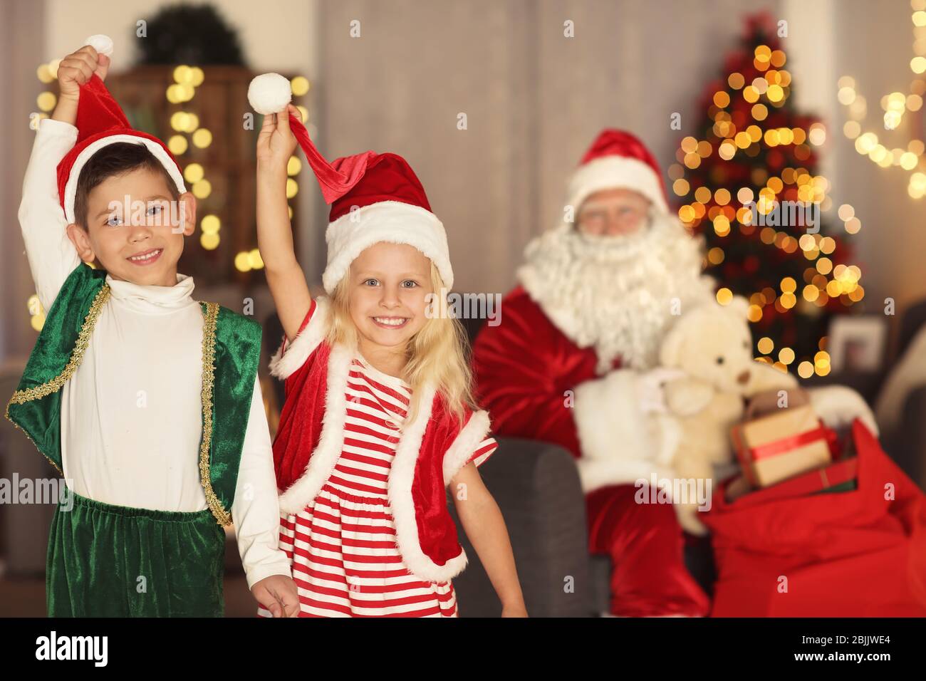 Cute elf kids in room beautifully decorated for Christmas Stock Photo ...
