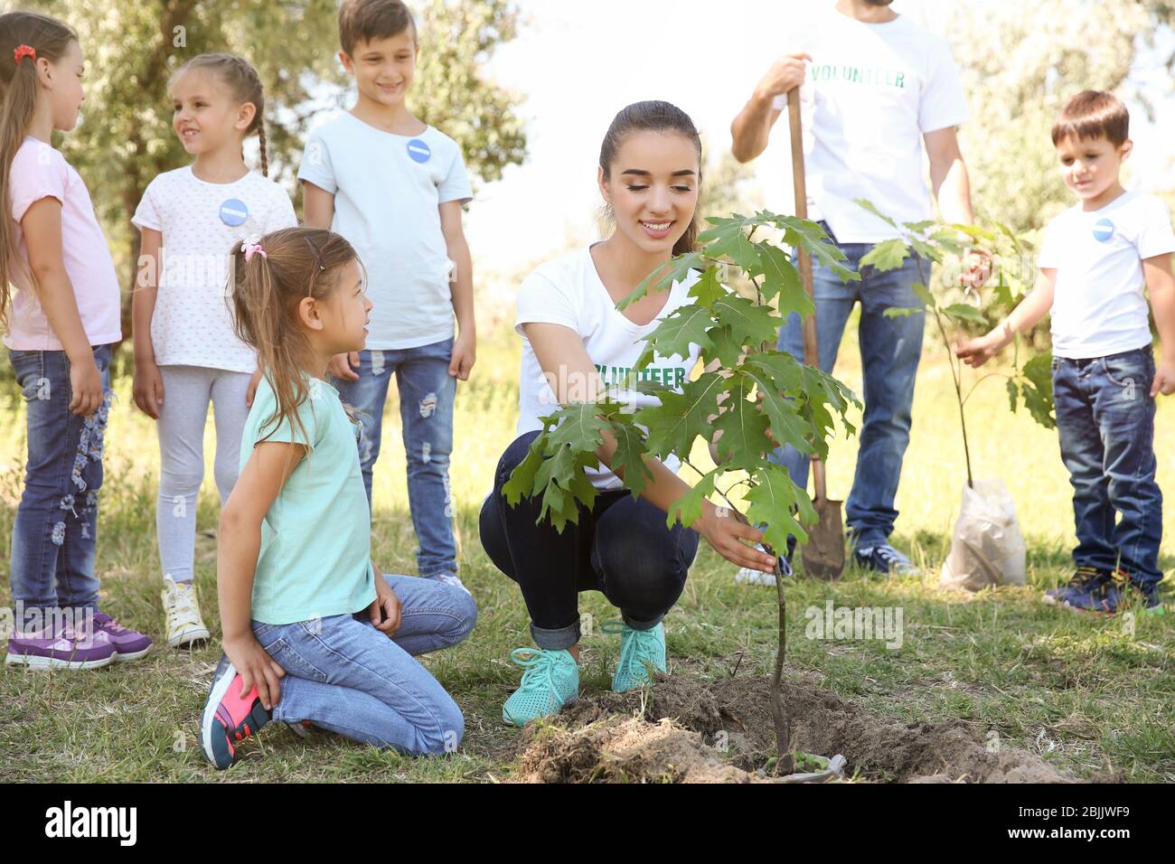 Children planting tree in park hi-res stock photography and images - Alamy