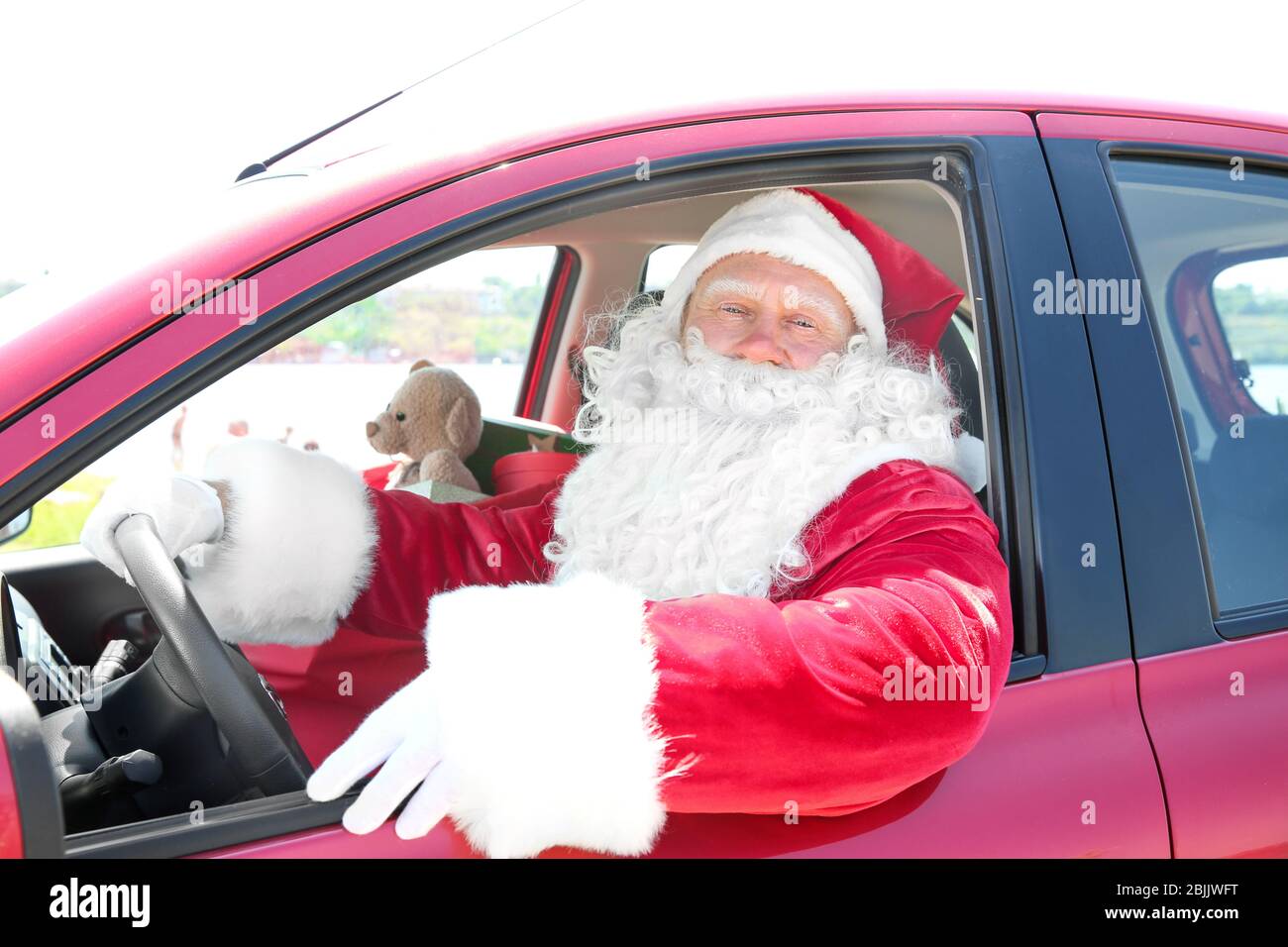 Authentic Santa Claus looking out of car window Stock Photo - Alamy