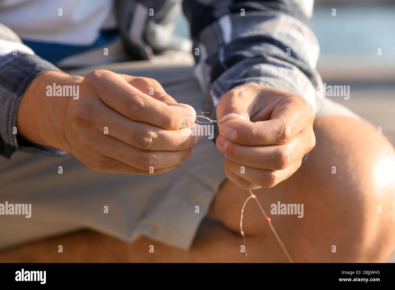 Hands tying hook hi-res stock photography and images - Alamy