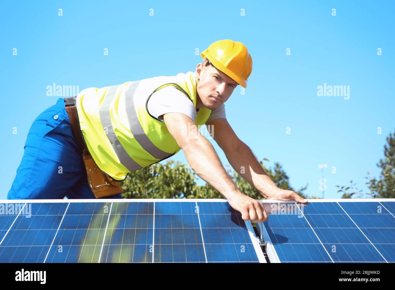 Worker installing solar panels outdoors Stock Photo - Alamy