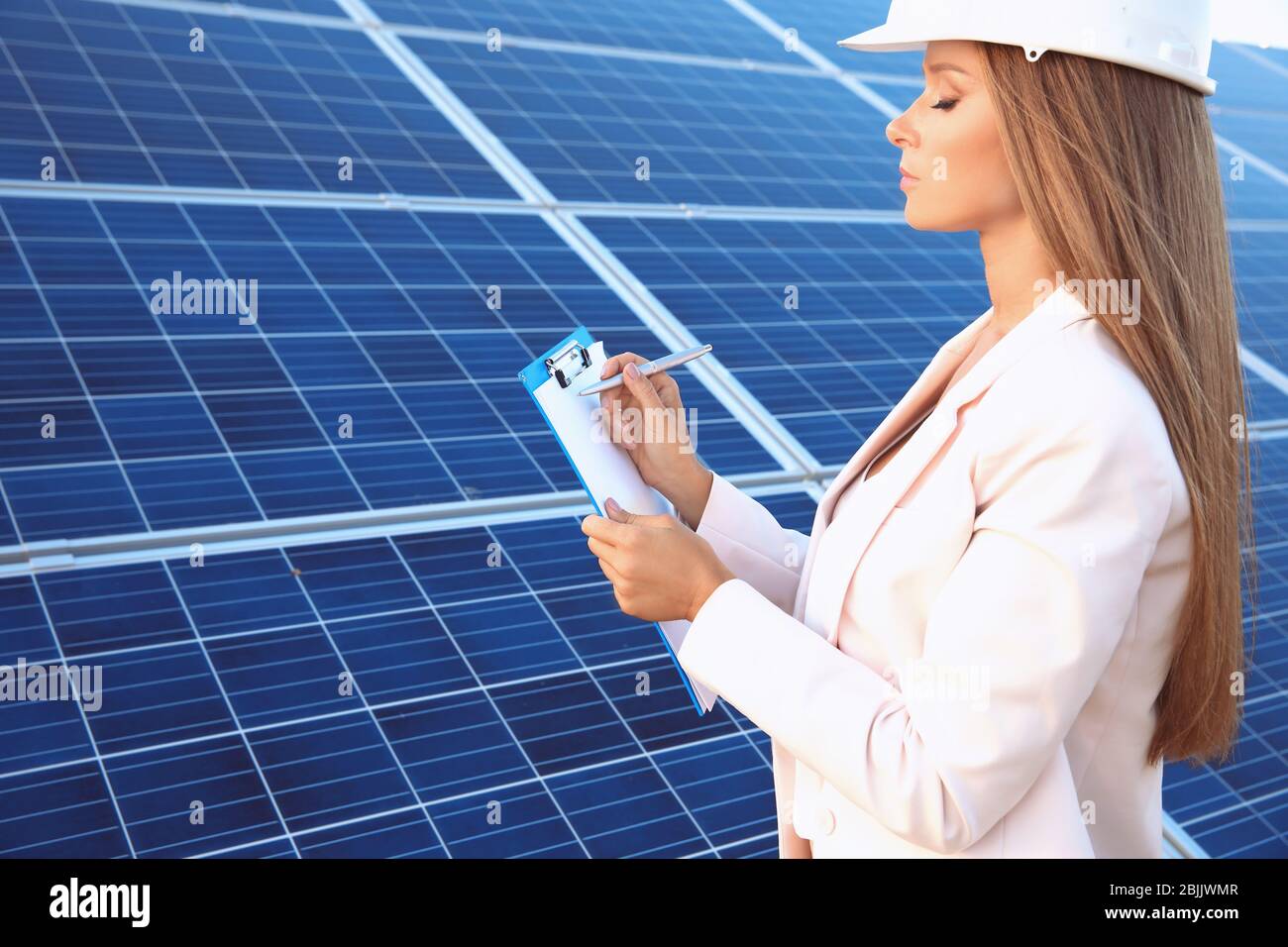 Female engineer developing project on installation of solar panels ...