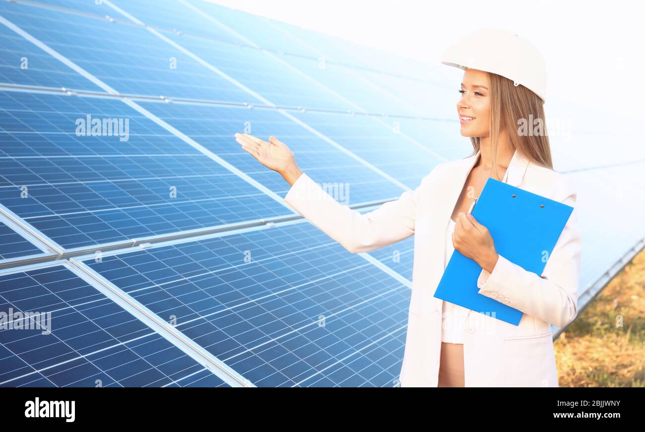 Female engineer developing project on installation of solar panels ...