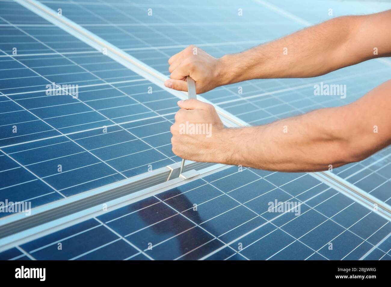 Hands of young worker installing solar panels outdoors Stock Photo - Alamy