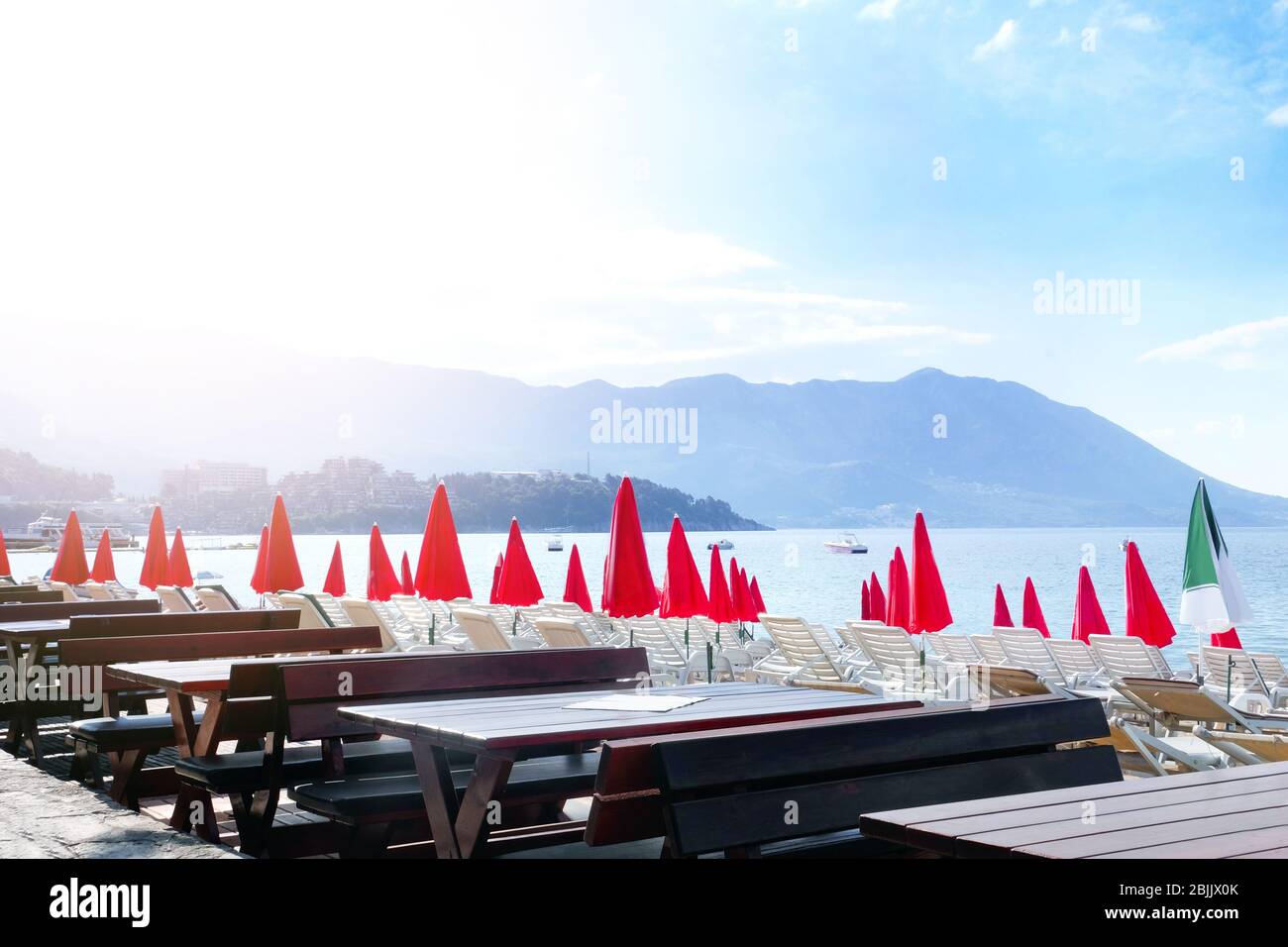 Empty sunbeds with umbrellas on beach Stock Photo - Alamy