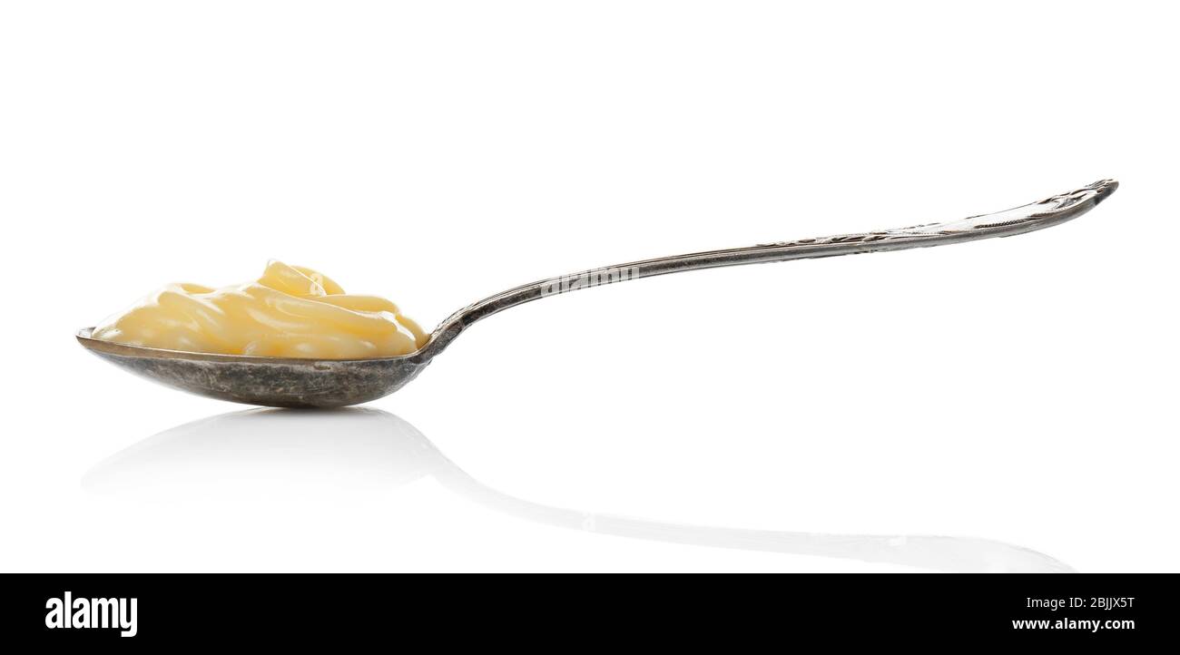 Metal spoon with vanilla pudding on white background Stock Photo - Alamy