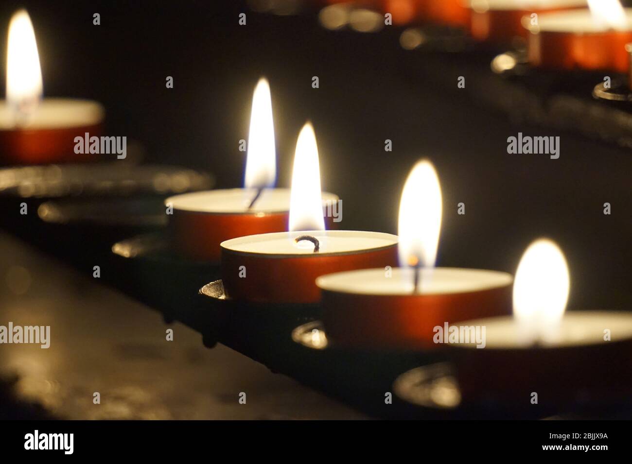 Burning small candles - religion concept Stock Photo - Alamy