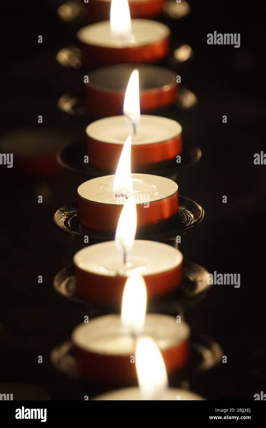 Burning small candles - religion concept Stock Photo - Alamy