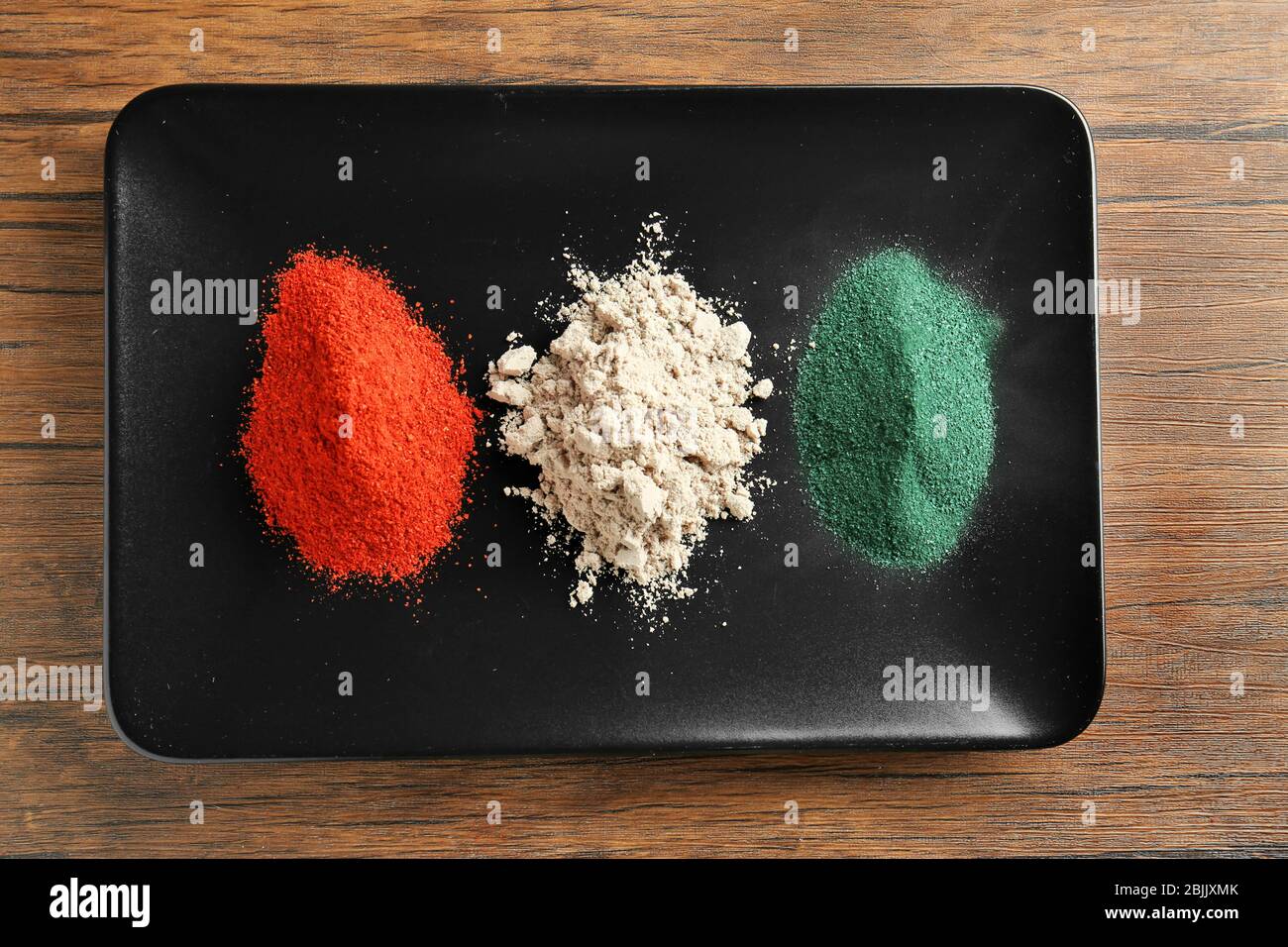 Plate with different colorful superfood powders on table Stock Photo ...