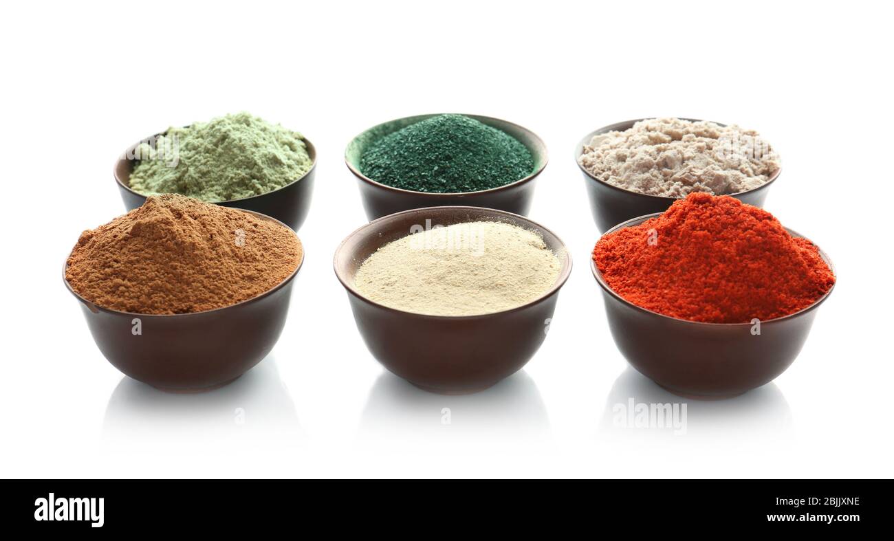 Different colorful superfood powders in bowls on white background Stock ...