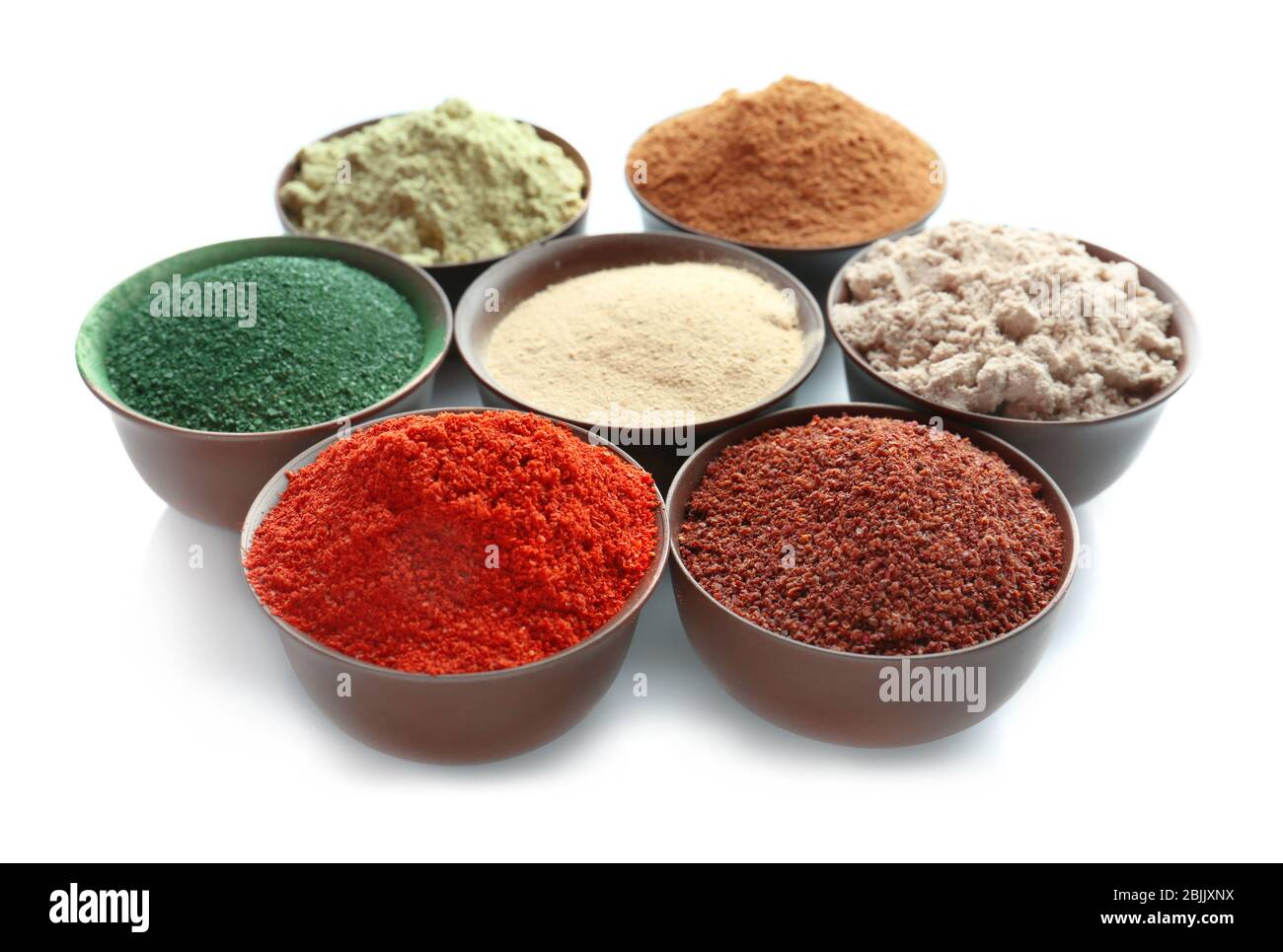 Different colorful superfood powders in bowls on white background Stock ...