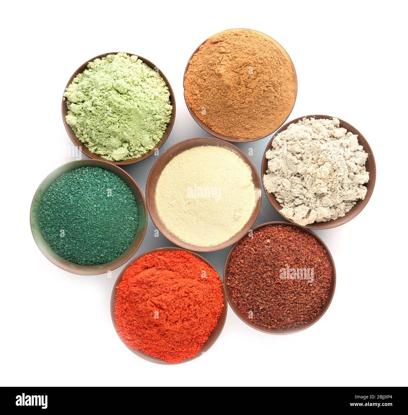 Different colorful superfood powders in bowls on white background Stock ...