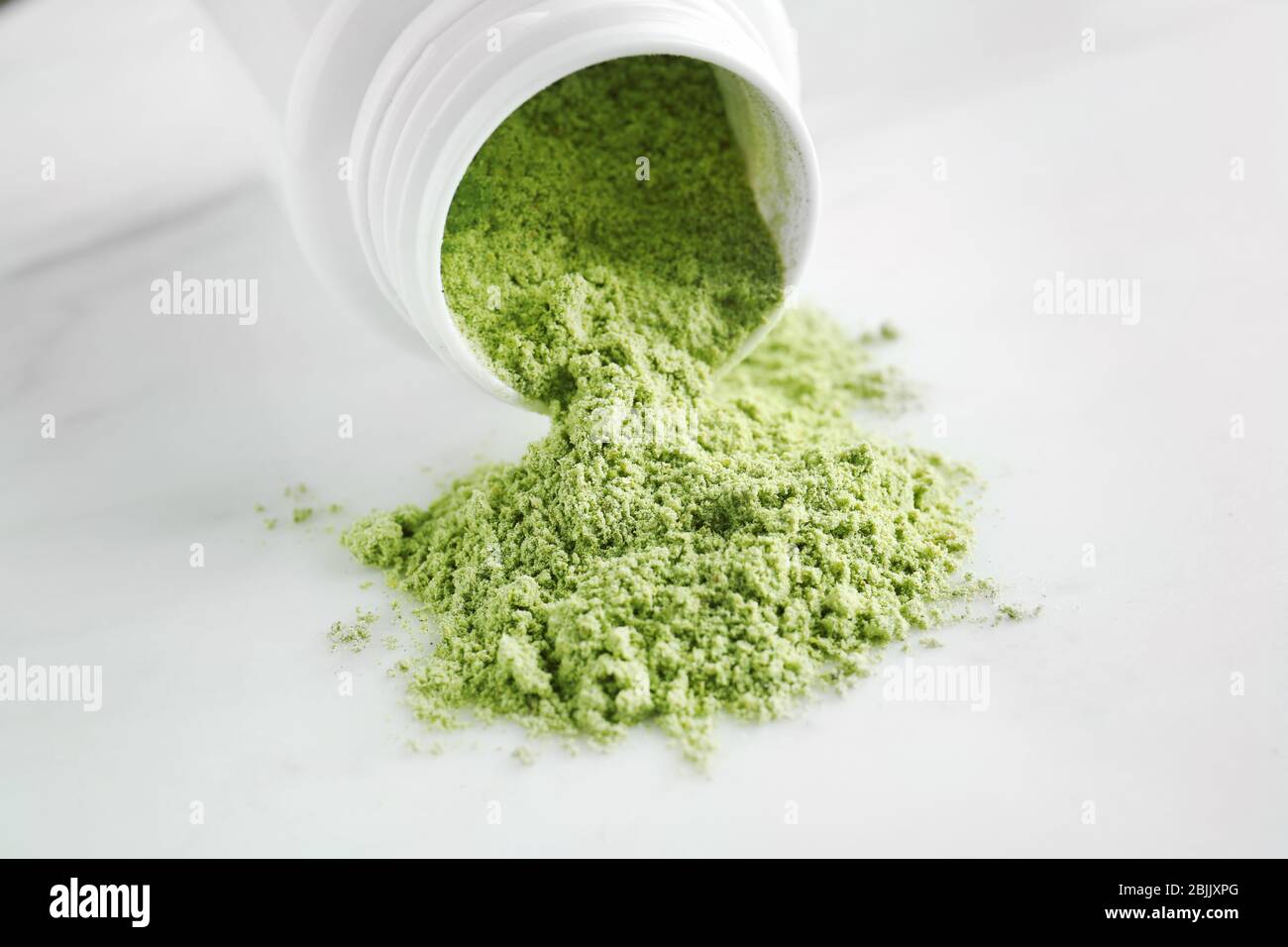 Plastic container with superfood powder on table Stock Photo - Alamy