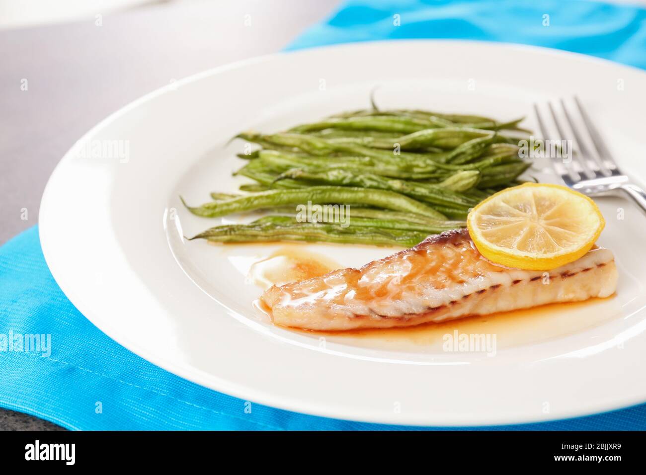 Plate with tasty fish and green beans, closeup Stock Photo - Alamy