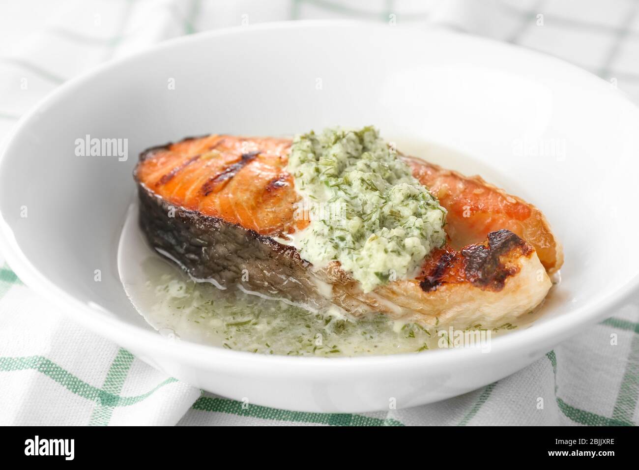 Plate of tasty fish with sauce on table, closeup Stock Photo - Alamy