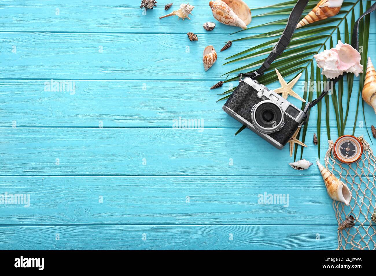 Composition with camera and compass on wooden background. Summer ...