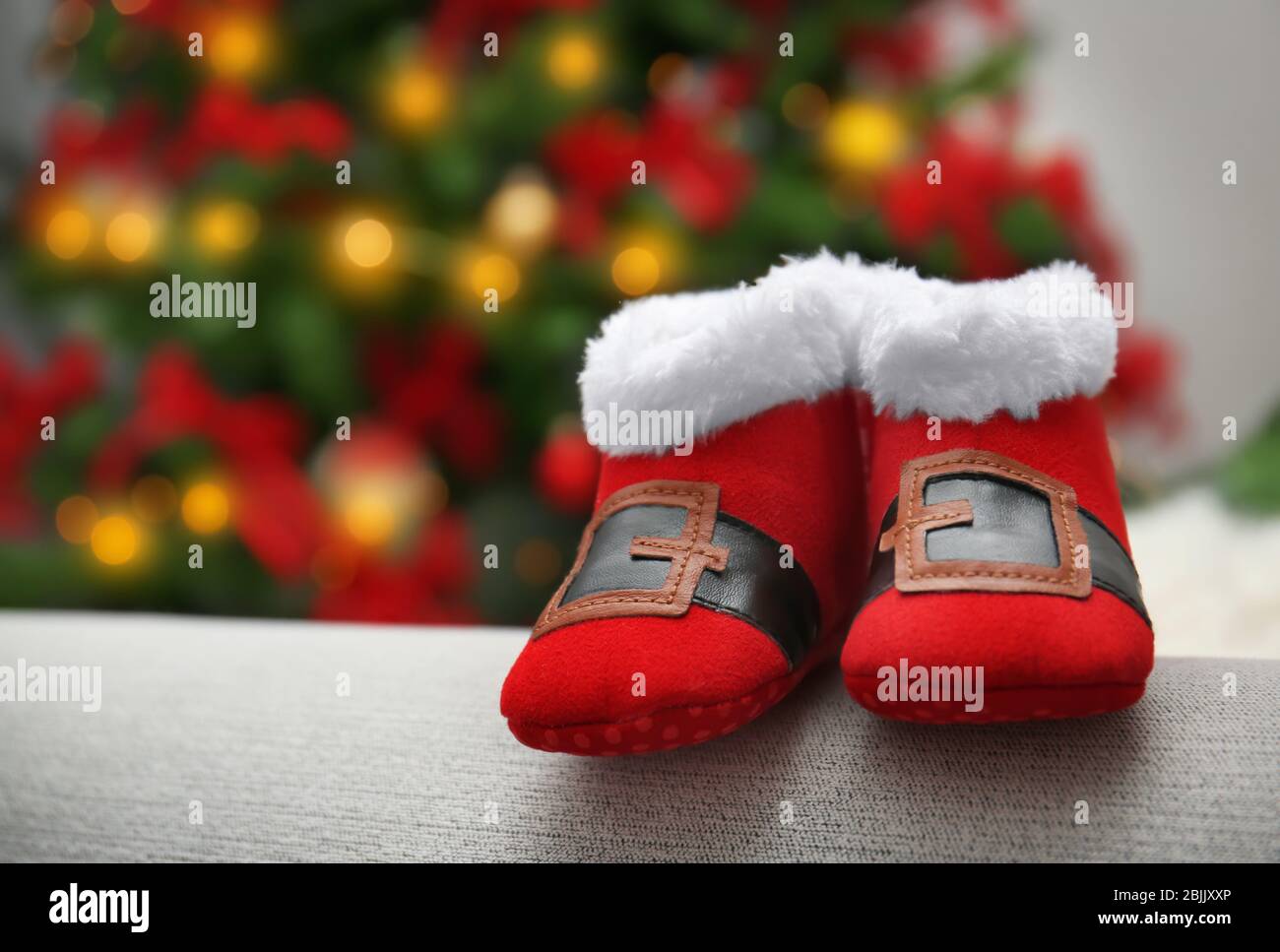Christmas baby booties on blurred background Stock Photo - Alamy
